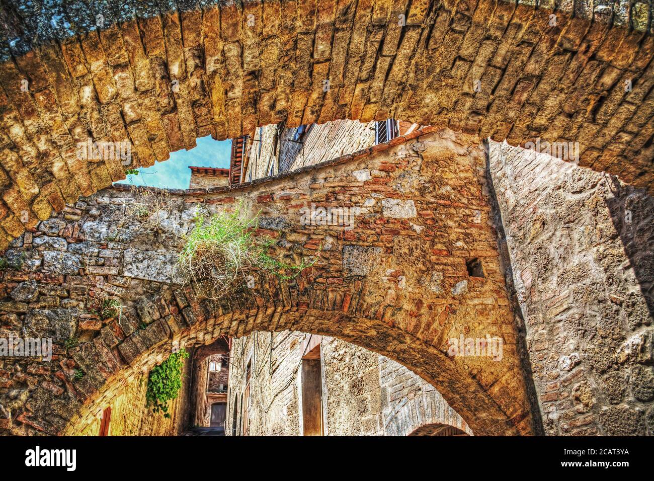 old brick arches in San Gimignano, Italy Stock Photo - Alamy
