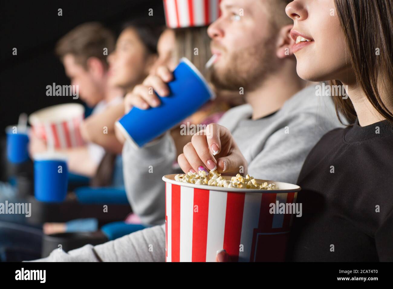 Grabbing popcorn from bucket hi-res stock photography and images - Alamy
