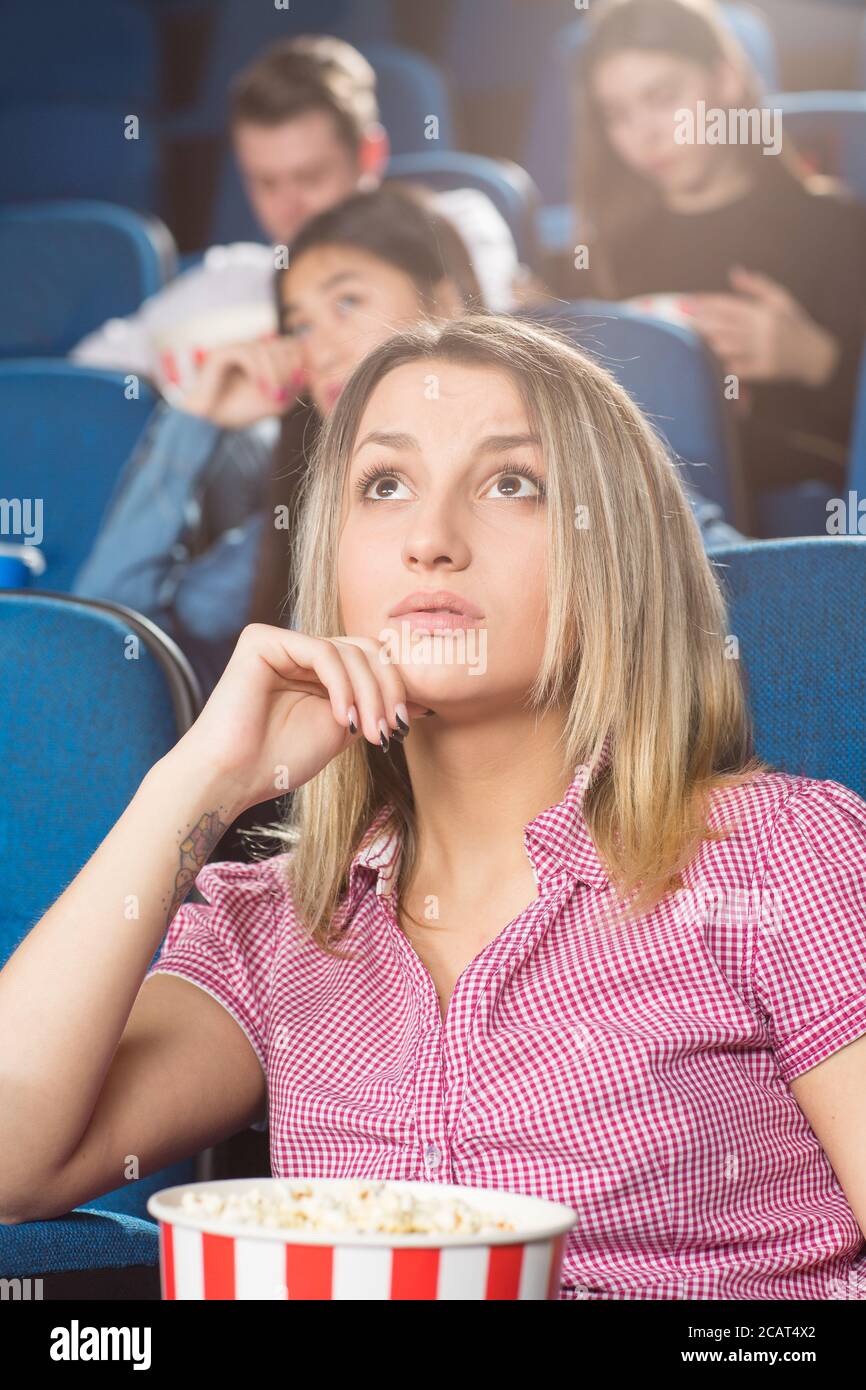 Time for drama. Young beautiful woman watching drama movie looking sad ...