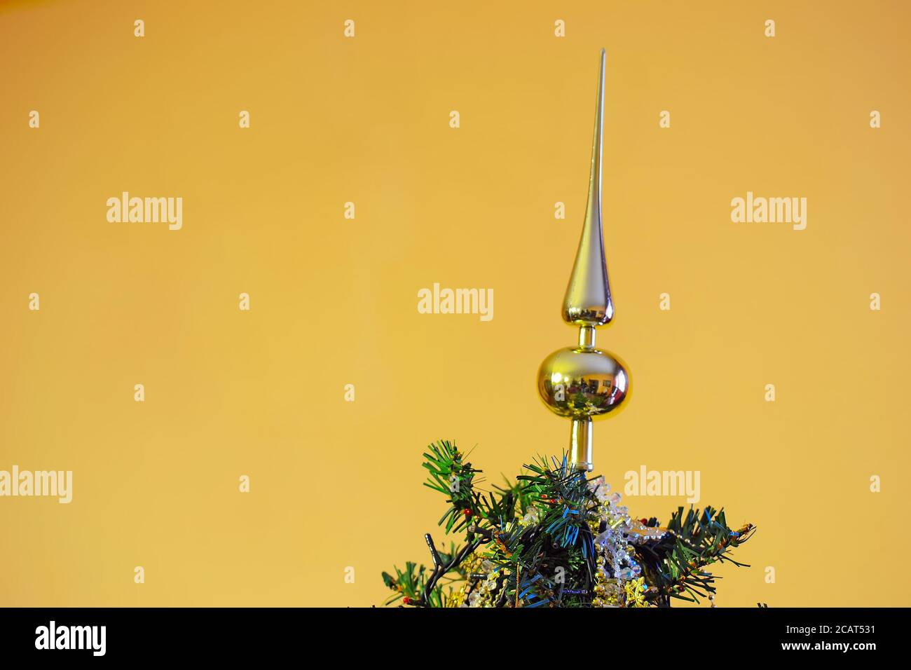 Christmas tree topper on a golden background Stock Photo - Alamy