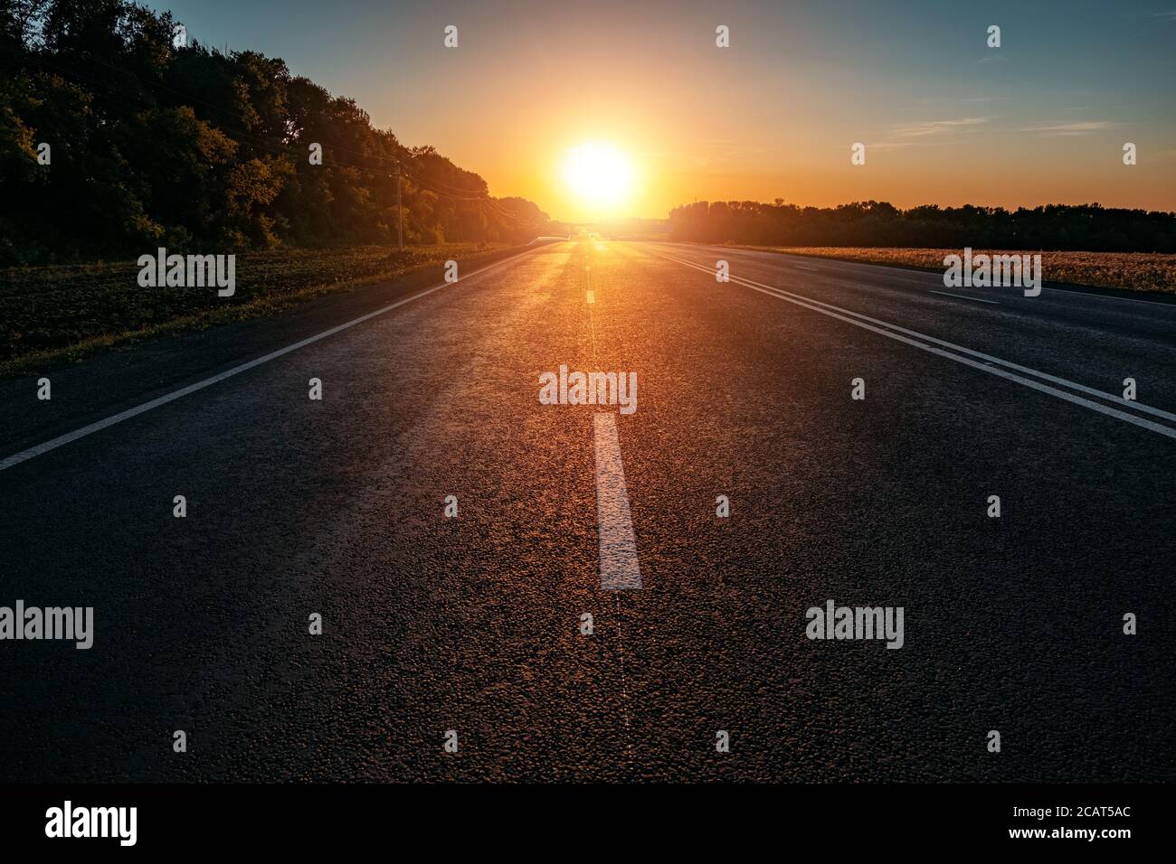 Evening sunlight above the asphalt road at the sunset Stock Photo - Alamy