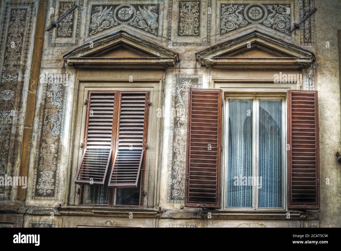 windows in a painted wall in Florence, Italy Stock Photo - Alamy