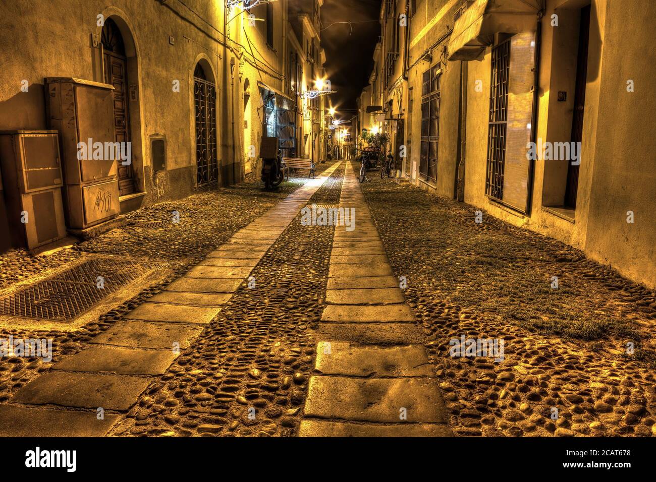 narrow street in Alghero old town by night, Italy Stock Photo - Alamy