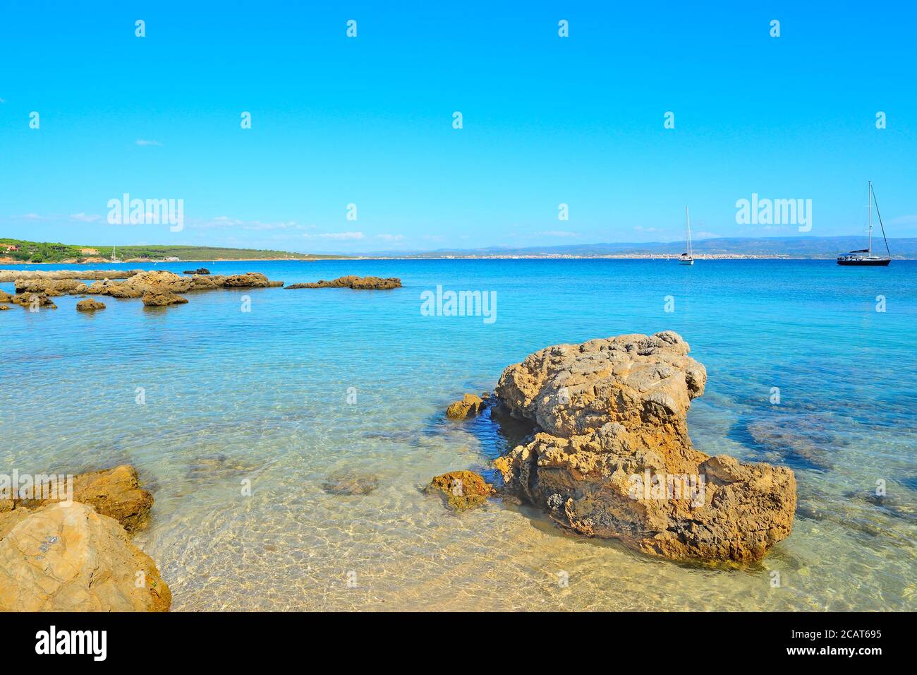 yellow rocks and blue water in Lazzaretto beach, Italy Stock Photo - Alamy