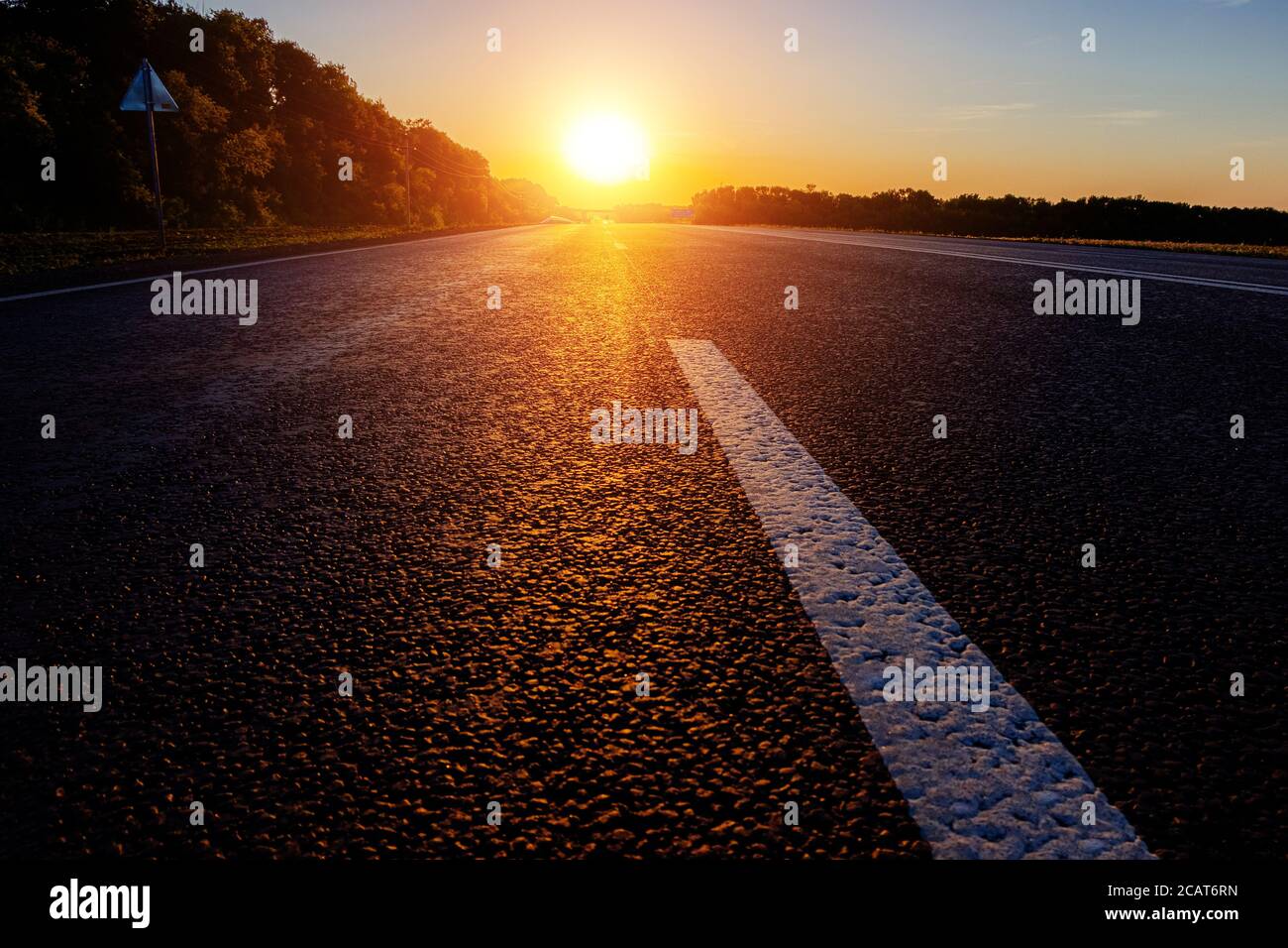Evening sunlight above the asphalt road at the sunset Stock Photo - Alamy