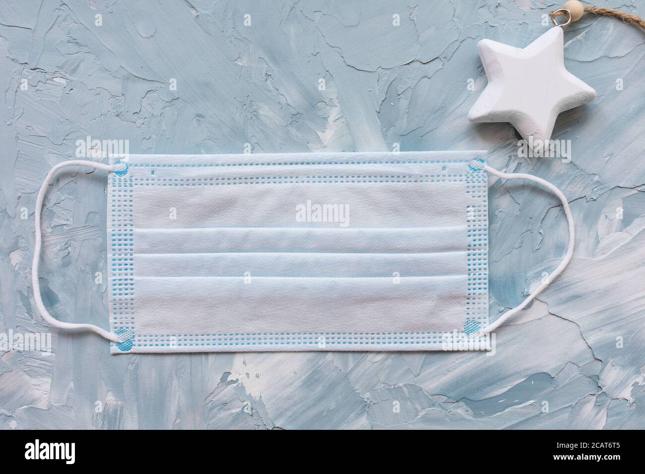 Blue surgical face mask and christmas star Stock Photo - Alamy