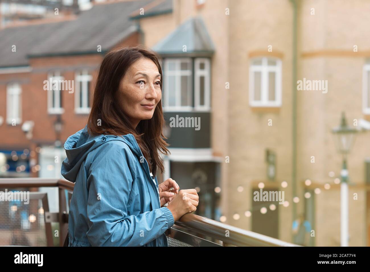 Asian woman in a blue coat walking around Europe city Stock Photo - Alamy