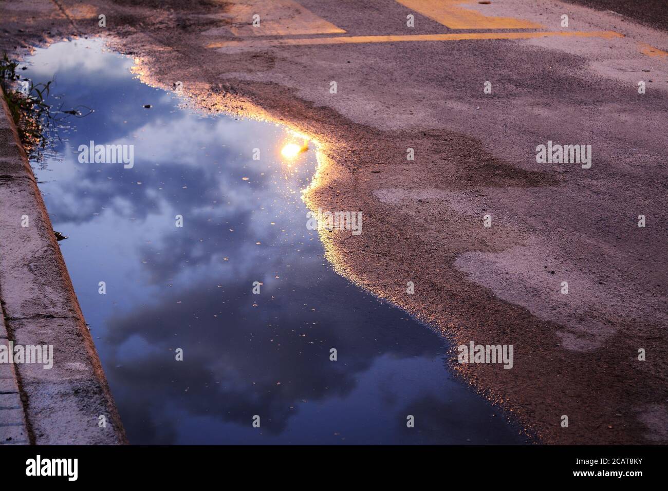 cloudy sky reflected in a puddle Stock Photo - Alamy