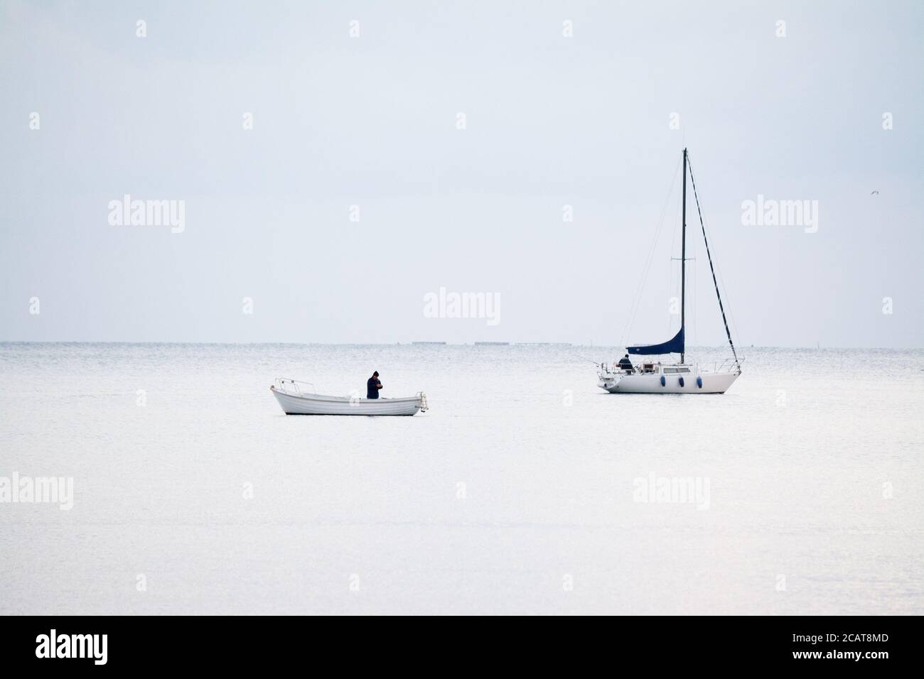 white boats in a white sea under a white sky Stock Photo - Alamy