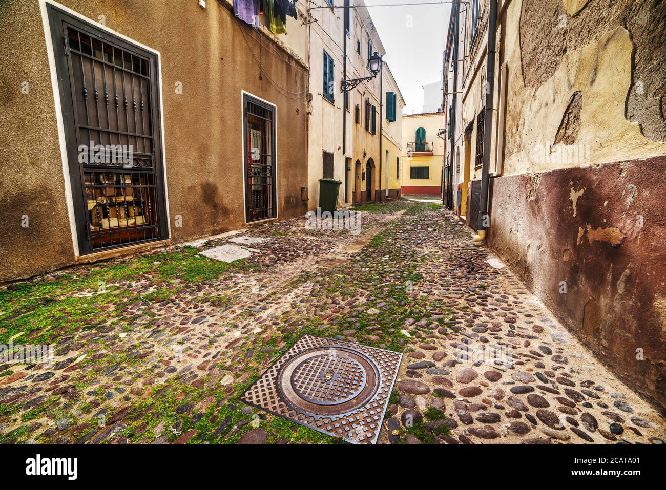 narrow street in Alghero old town, Italy Stock Photo - Alamy