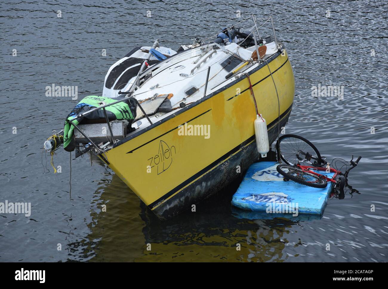 An abandoned sailboat used as an illegal live aboard vessel, lists on ...