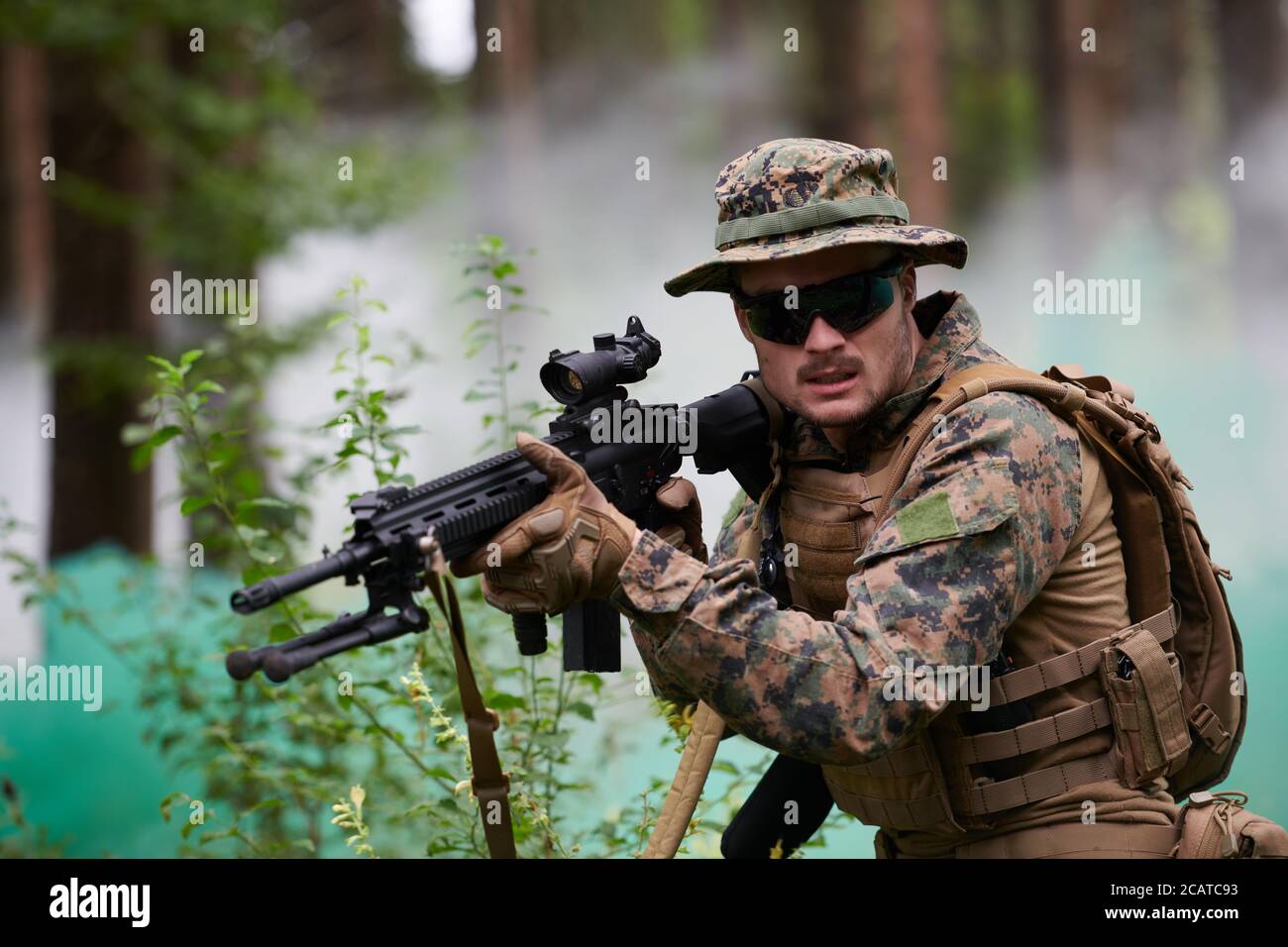 modern warfare soldier in action aiming at weapon laser sight optics in ...