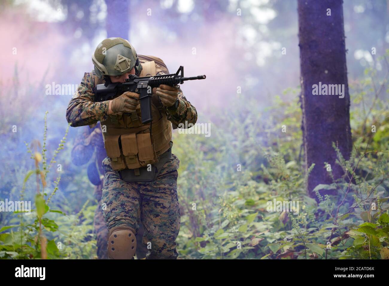 modern warfare soldier in action aiming at weapon laser sight optics in ...