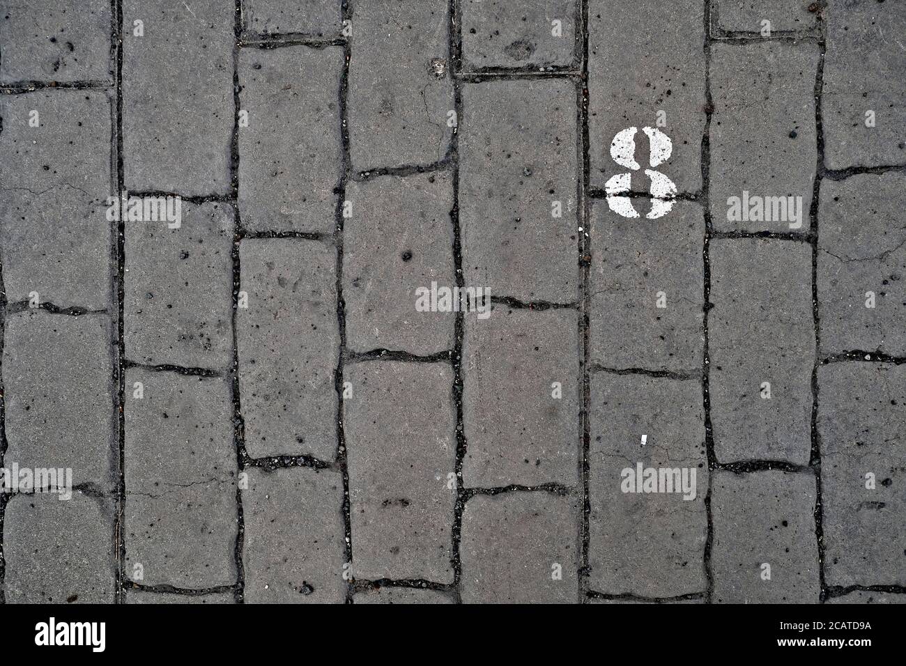 8, number eight, white stencil number on cobblestone surface Stock ...