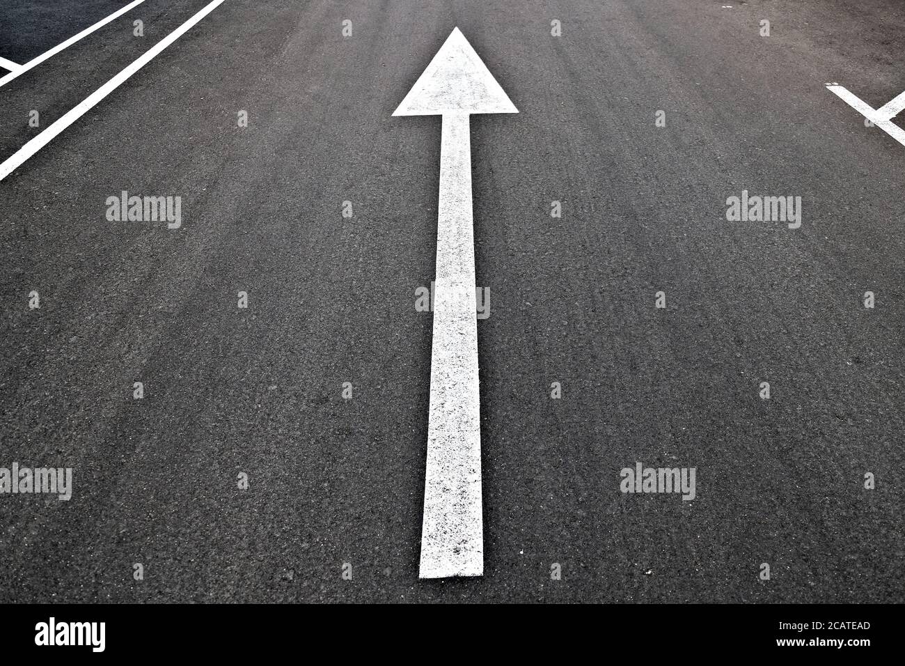 Long white arrow pointing up on black background, angled perspective ...