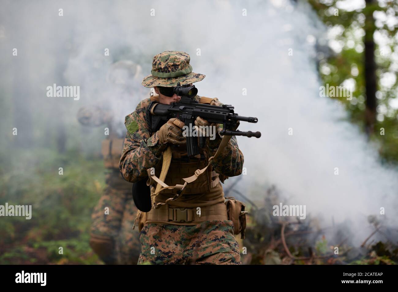 modern warfare soldier in action aiming at weapon laser sight optics in ...