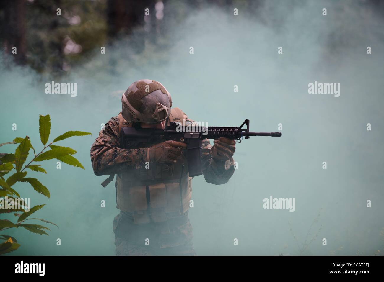modern warfare soldier in action aiming at weapon laser sight optics in ...