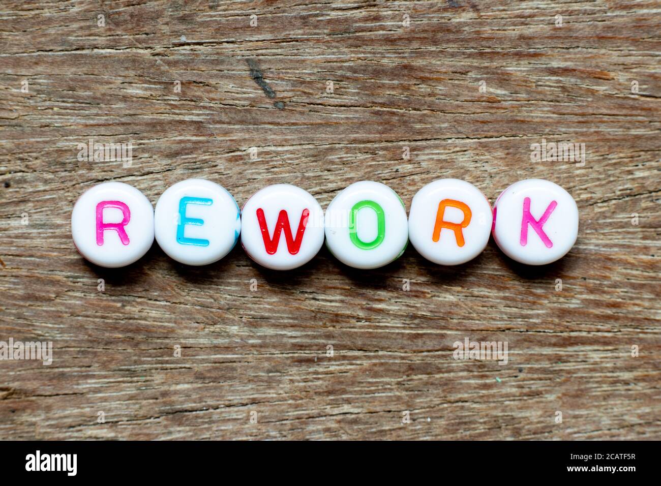 White bead with color letter in word rework on wood background Stock ...