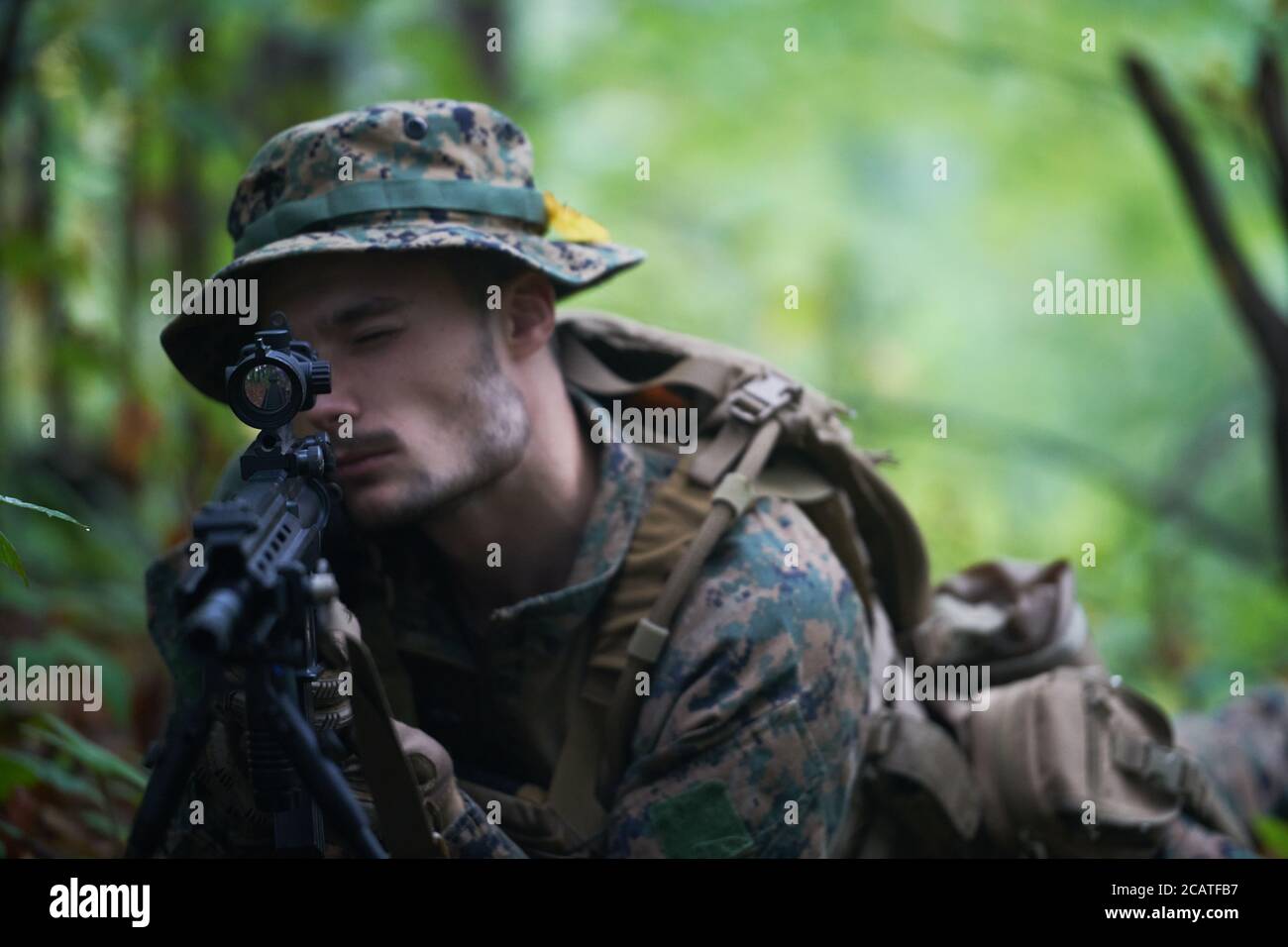 modern warfare soldier in action aiming at weapon laser sight optics in ...