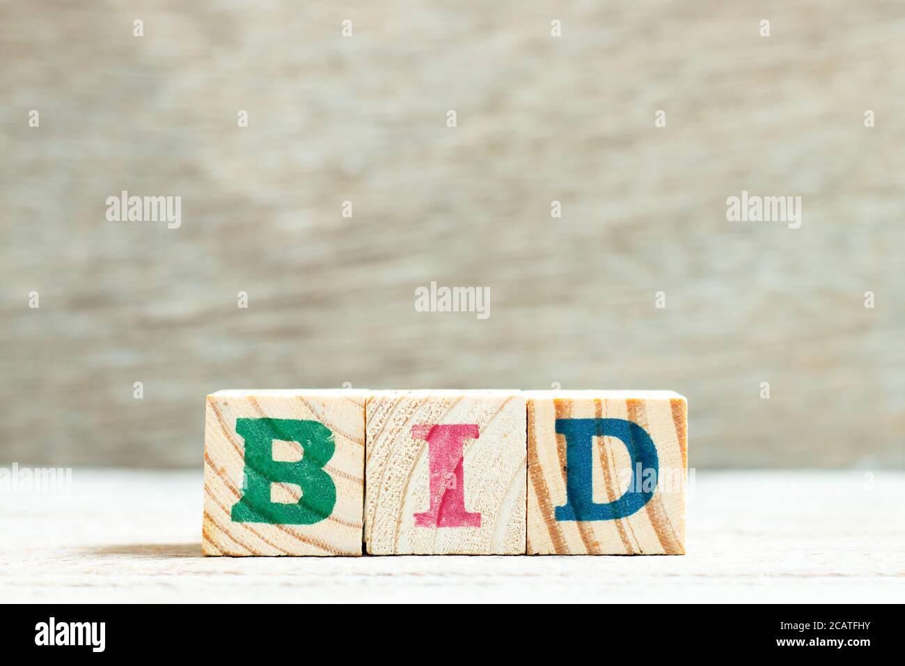 Alphabet letter in word bid on wood background Stock Photo - Alamy