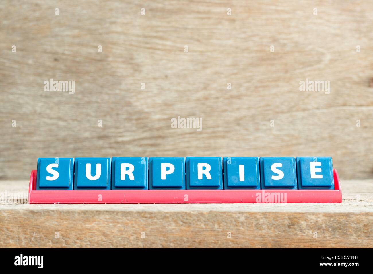 Tile letter on red rack in word surprise on wood background Stock Photo ...