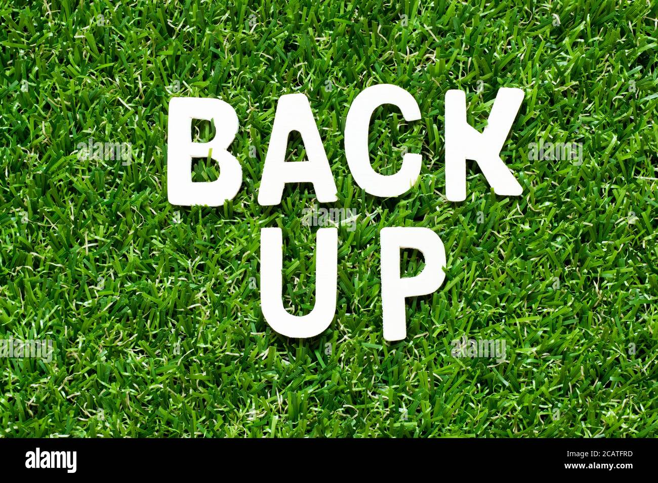 Wood alphabet letter in word back up on green grass background Stock ...