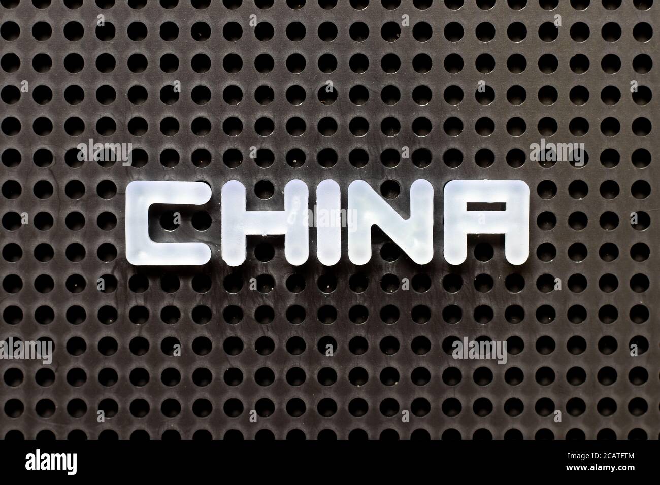 White color alphabet with word china on black pegboard background Stock ...
