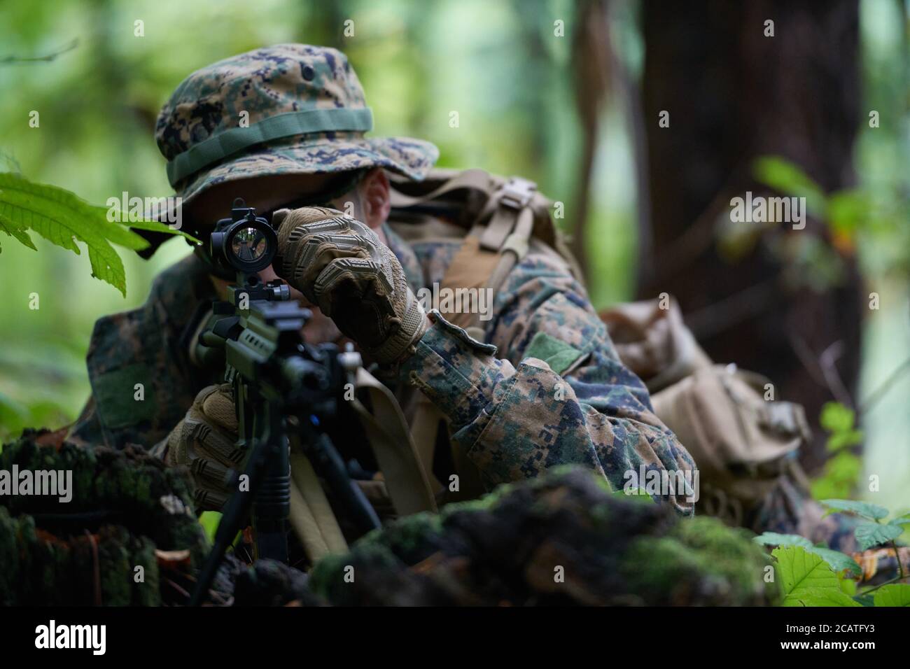 modern warfare soldier in action aiming at weapon laser sight optics in ...