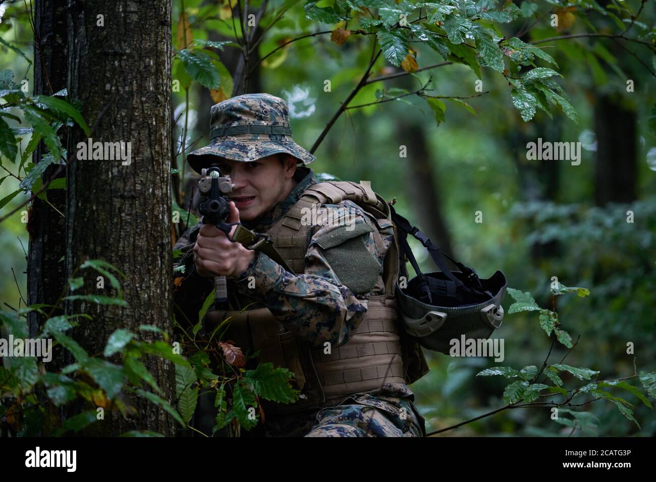 modern warfare soldier in action aiming at weapon laser sight optics in ...