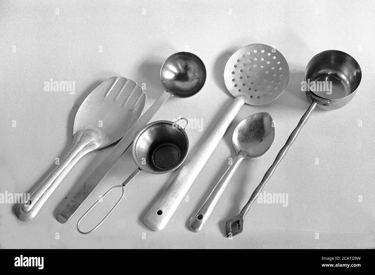 Arrangement of kitchen tools neatly placed diagonally on white ...