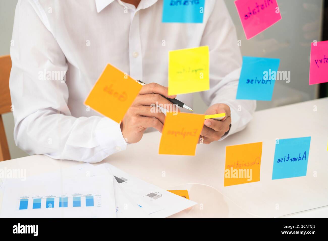 business people planning startup project placing sticky notes session ...