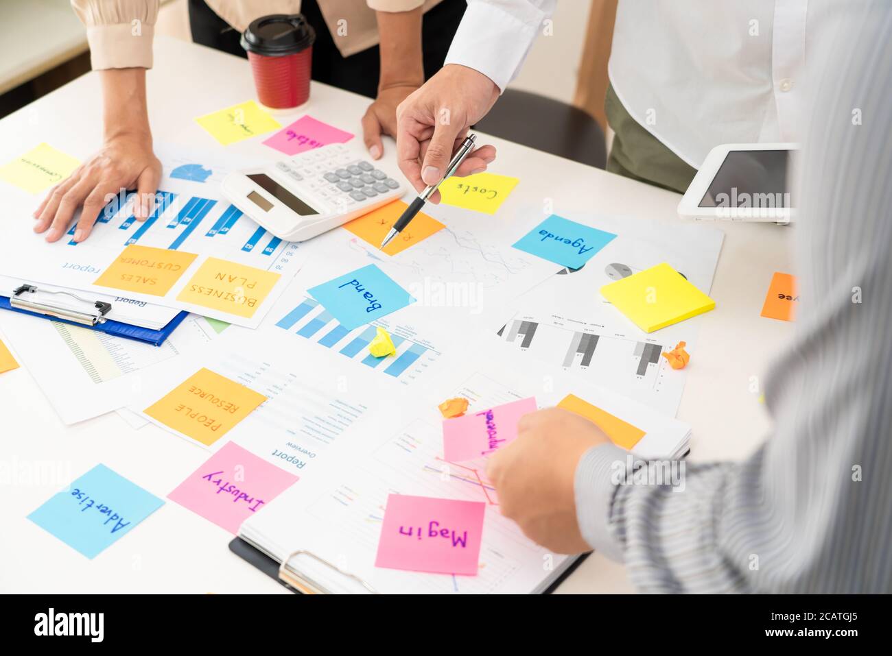 Creative group of business people brainstorming use sticky notes to ...