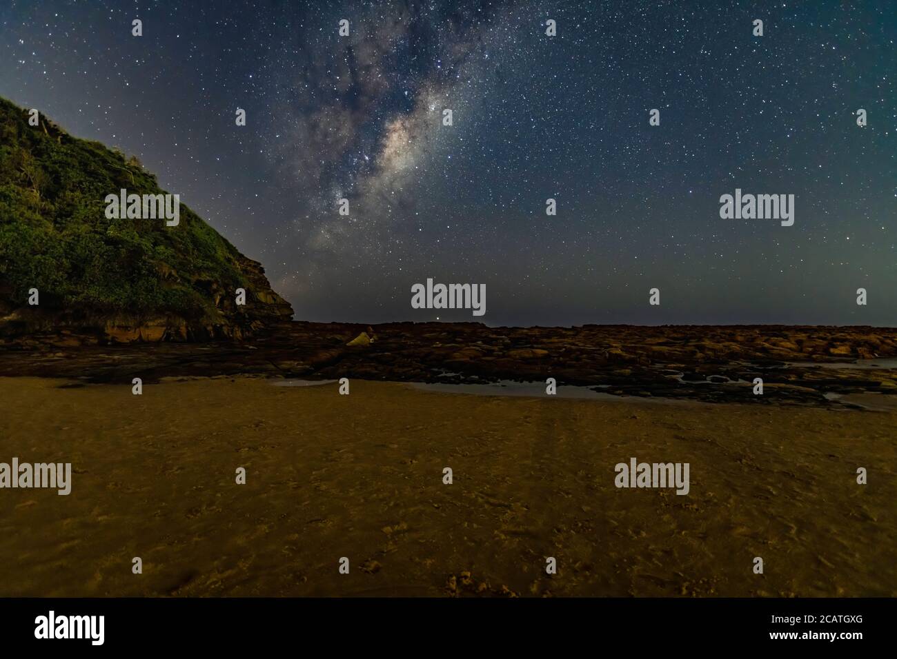 Stars and the Milky Way Night Sky with Rock Platform and Headland taken ...