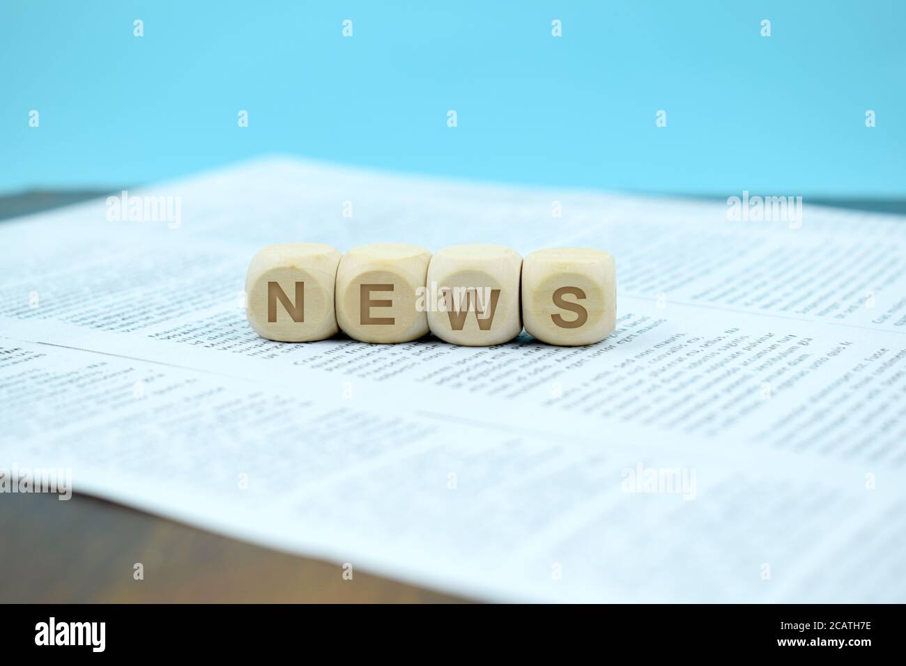 cubes with the word news on a newspaper Stock Photo - Alamy