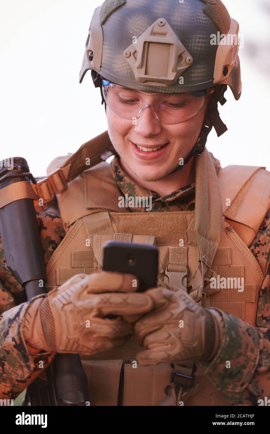 soldier using smart phone to contact family or girlfriend communication ...