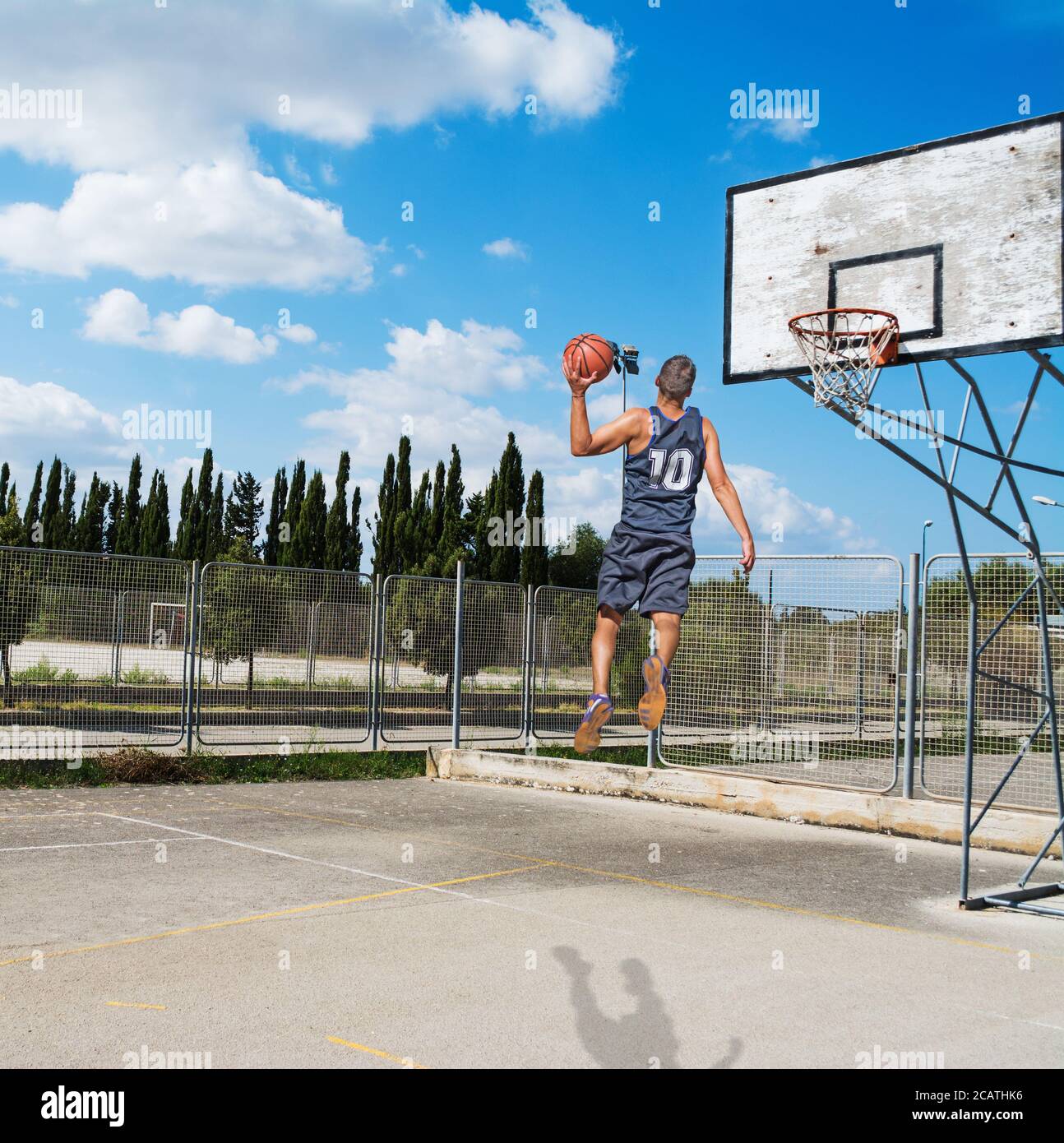 basketball player dunking in a playground Stock Photo - Alamy