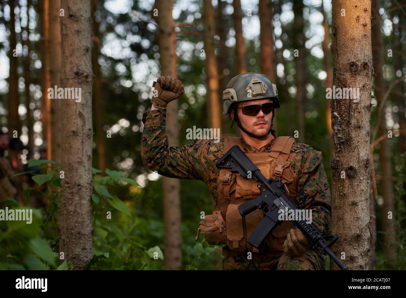modern warfare soldier officer is showing tactical hand signals to ...