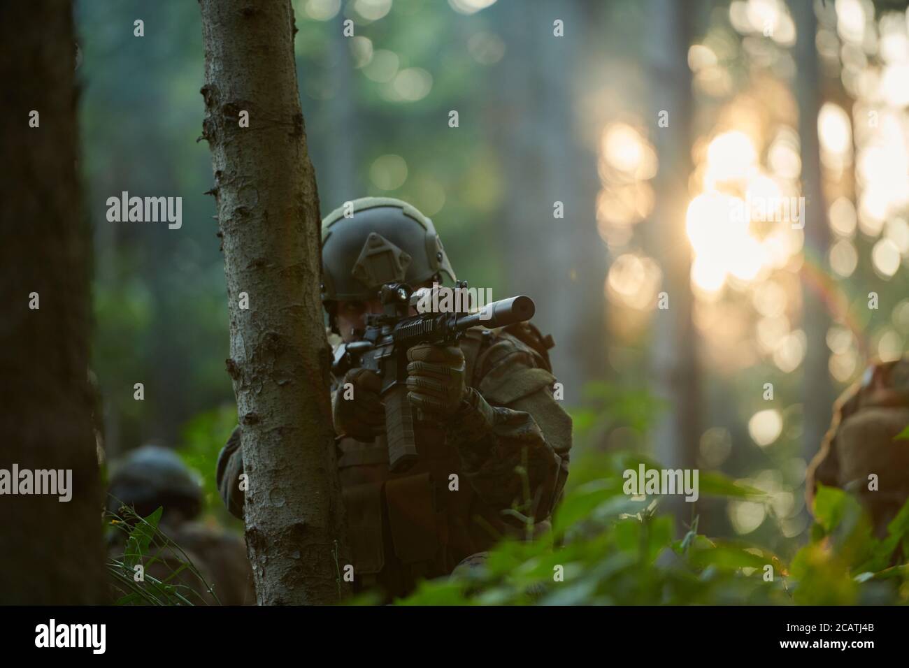 modern warfare soldier in action aiming at weapon laser sight optics in ...