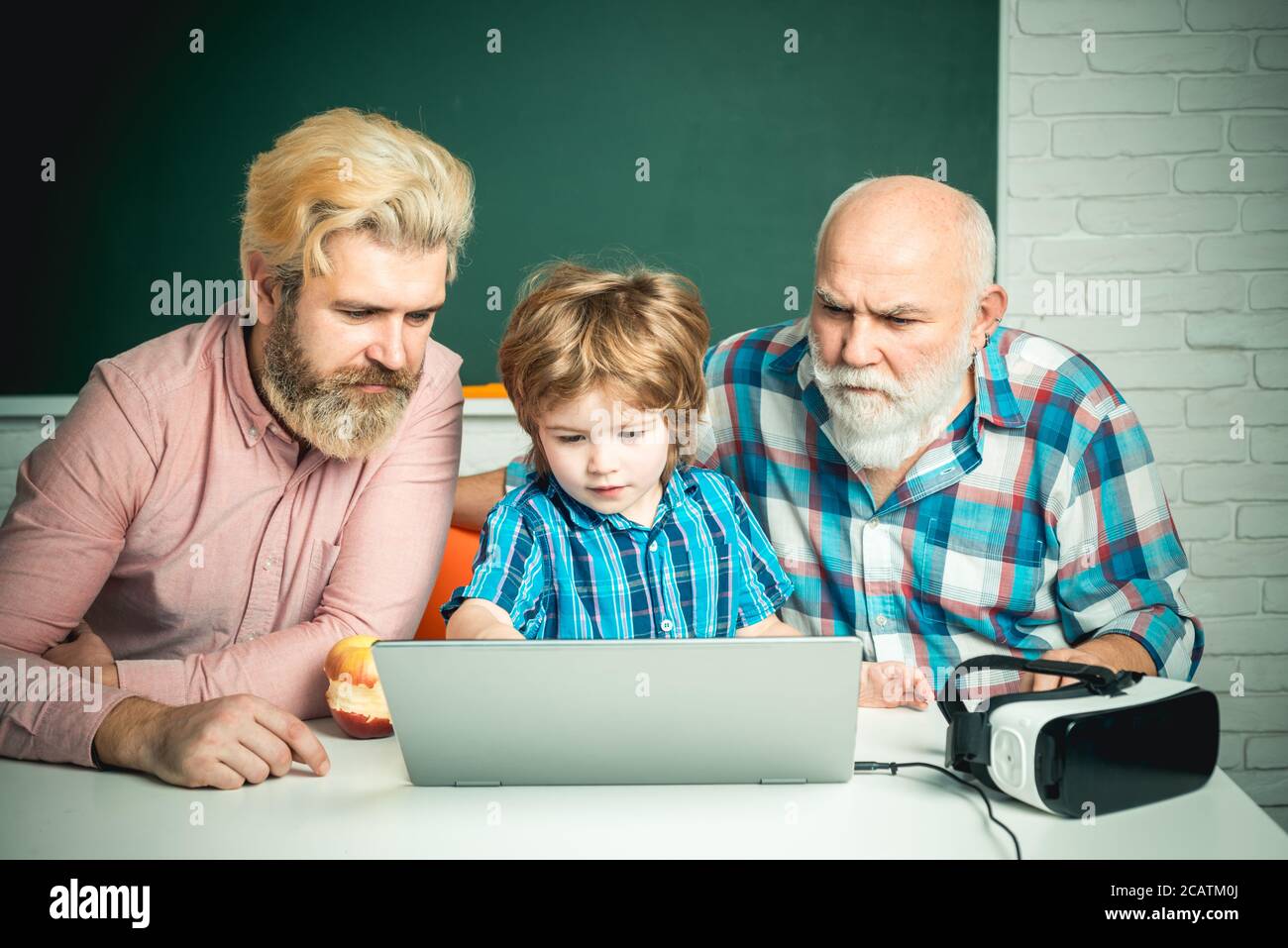 Senior man teaching laptop to his old son. Child studying from home ...