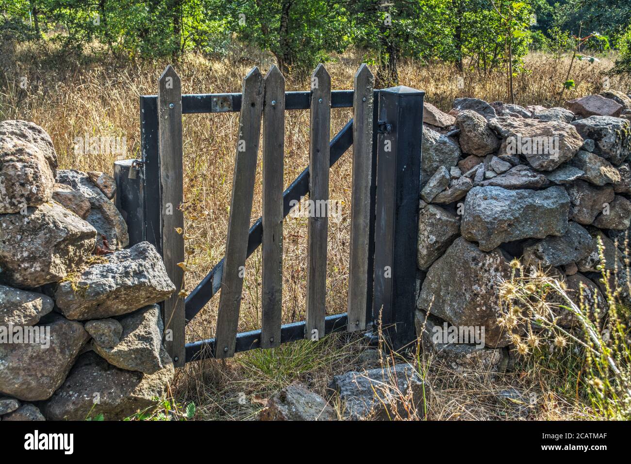 small wooden gate in a dry stone wall Stock Photo - Alamy