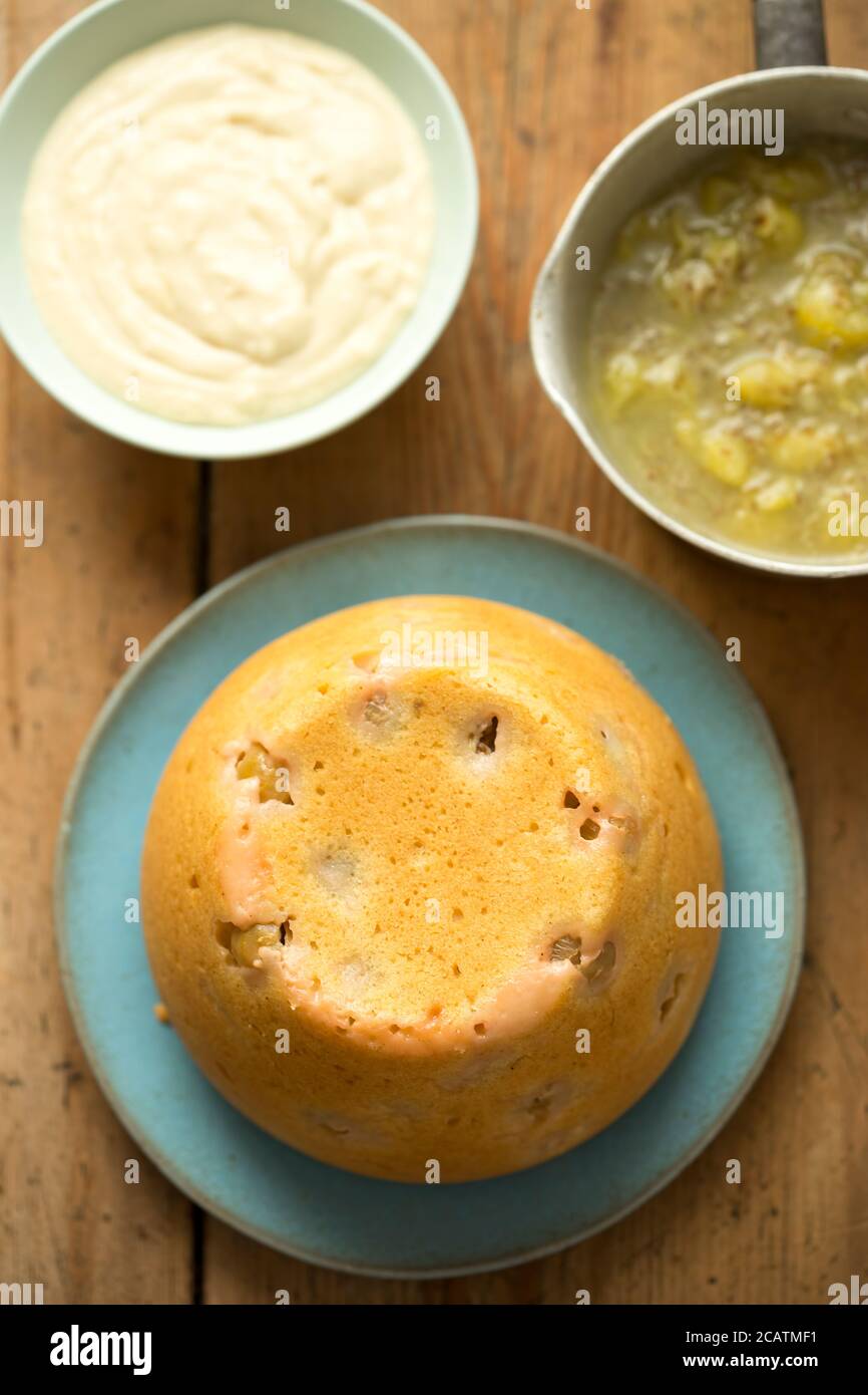 Cooked gooseberry summer pudding with vanilla custard and gooseberry ...