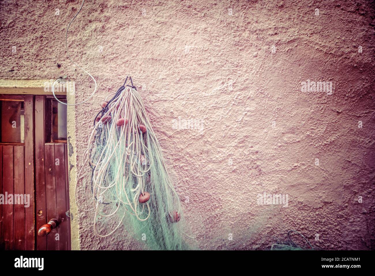 fisherman net hanging on a rustic wall Stock Photo - Alamy