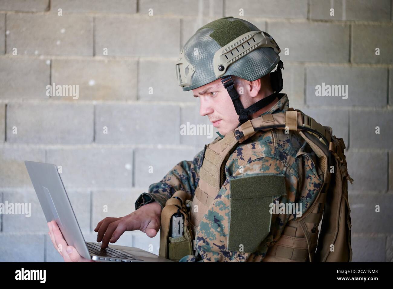 American soldier in military uniform using laptop computer for drone ...