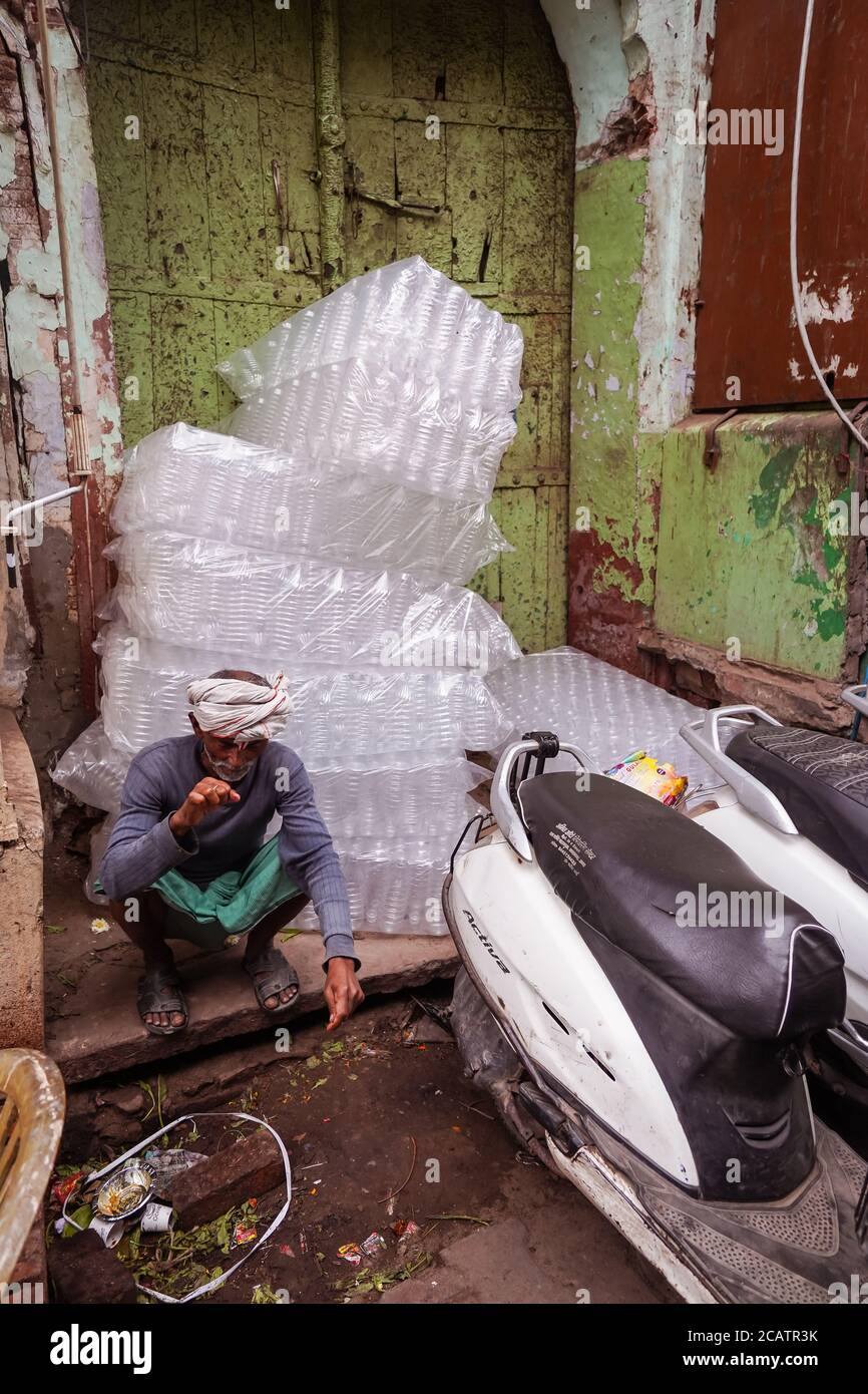 Agra / India - February 22, 2020: Indian man poor worker squatting on ...