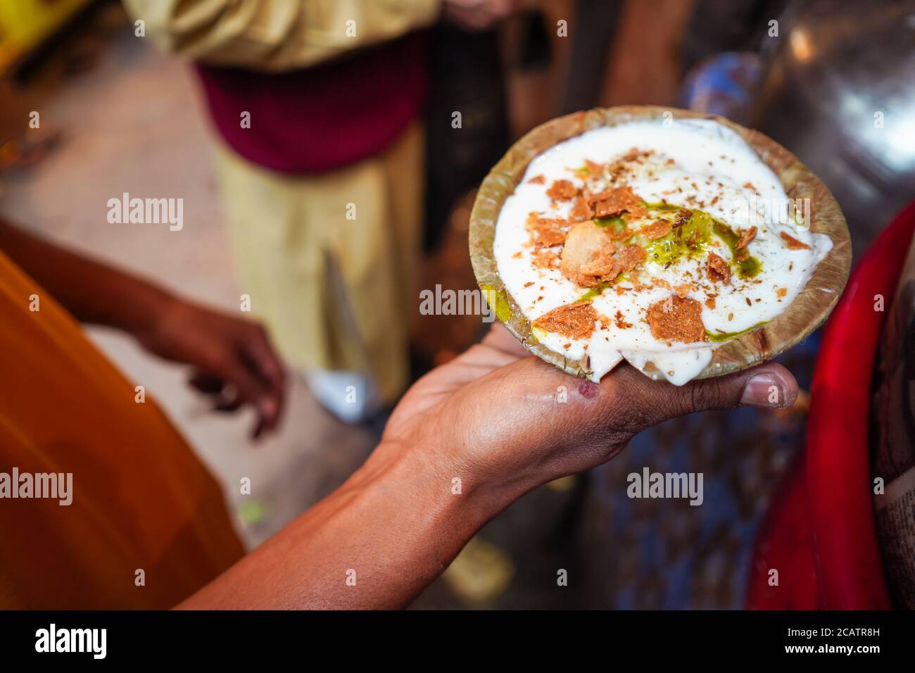 Detail of Indian snack held by hand in Agra downtown, India Stock Photo ...