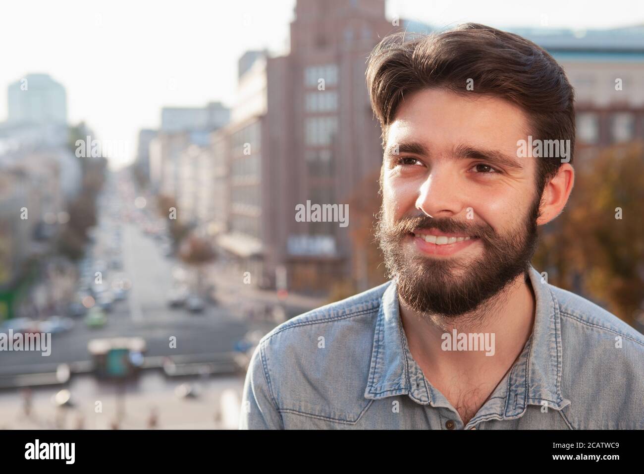 Close up portrait of a handsome bearded male hipster smiling joyfully ...