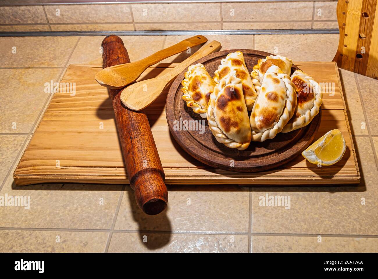 Wooden table with fresh homemade Empanadas (detailed close-up shot ...