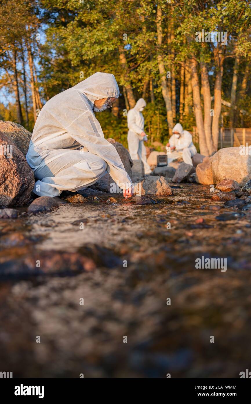 Female scientist collecting water sample from sea Stock Photo - Alamy