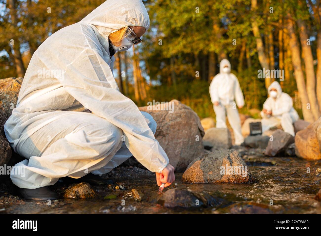 Female scientist collecting water sample from sea Stock Photo - Alamy