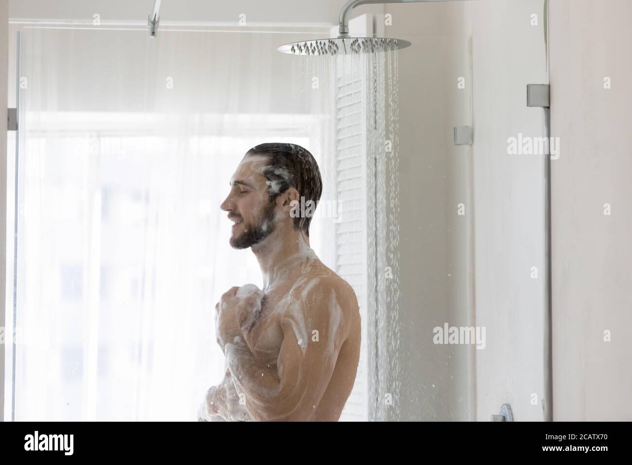 Young man taking shower hi-res stock photography and images - Alamy